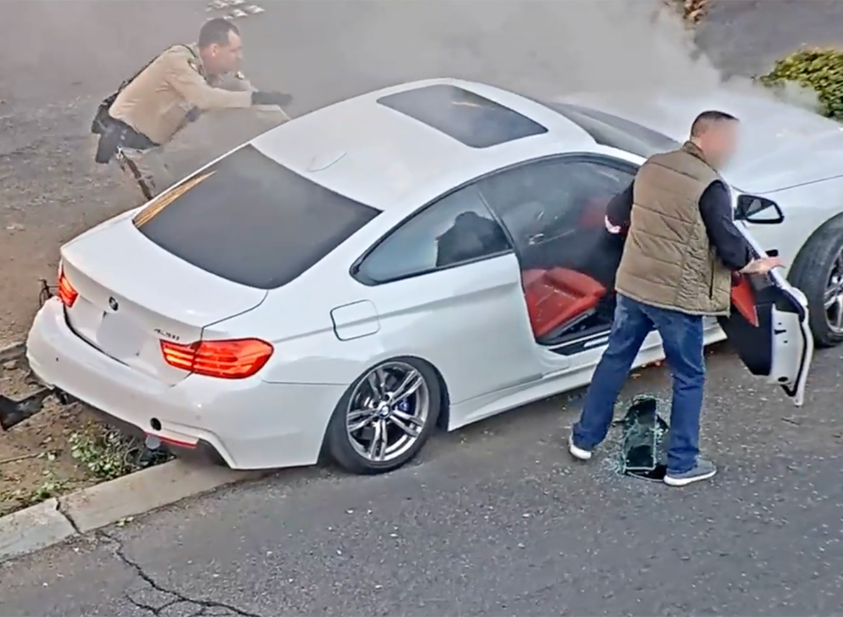 Police Officer And Good Samaritan Rescue Unconscious Driver